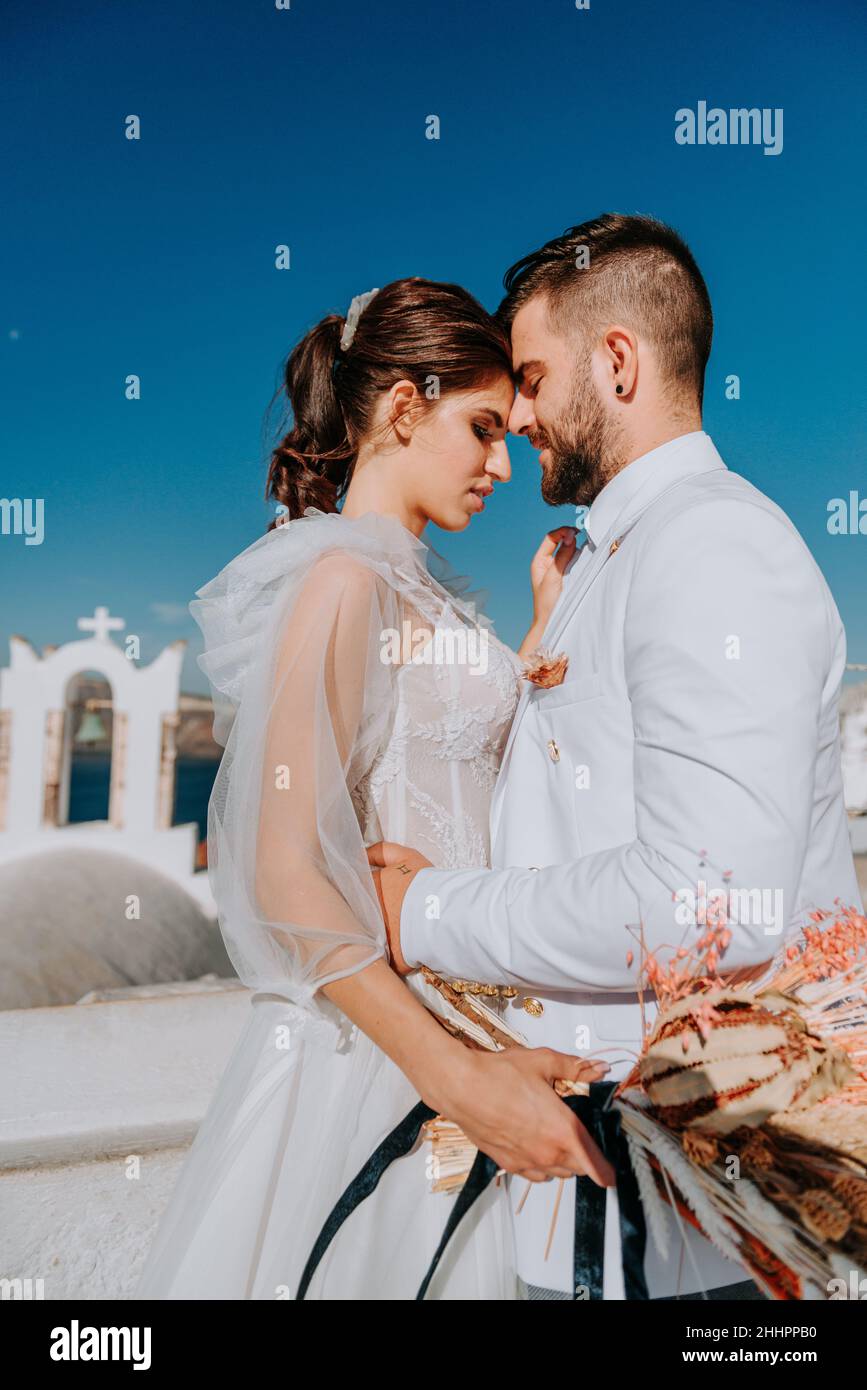 beautiful bride and groom in their summer wedding day on greek island ...