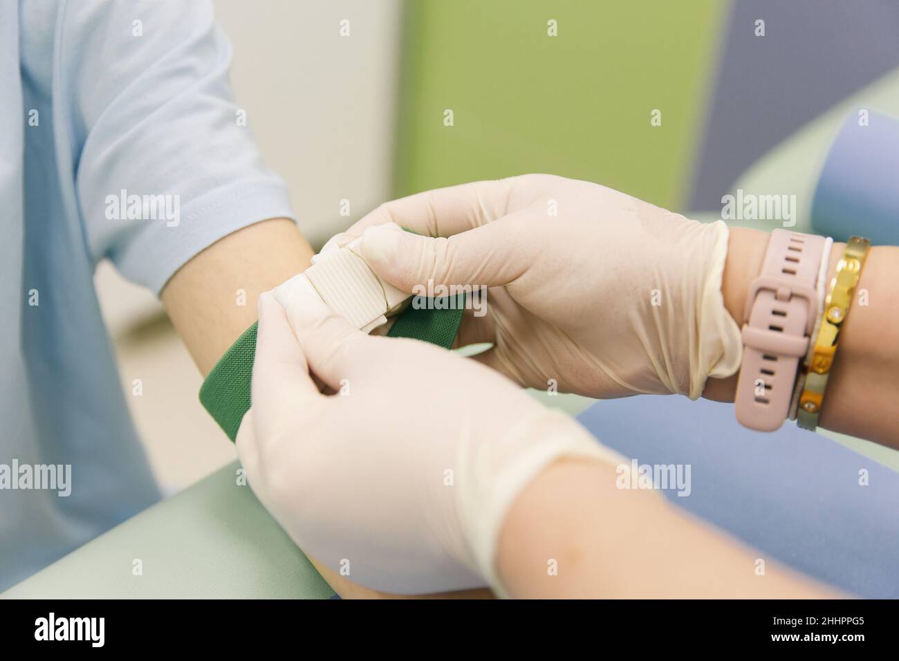 Taking a blood test from a vein in the treatment room. Nurse pricking a ...