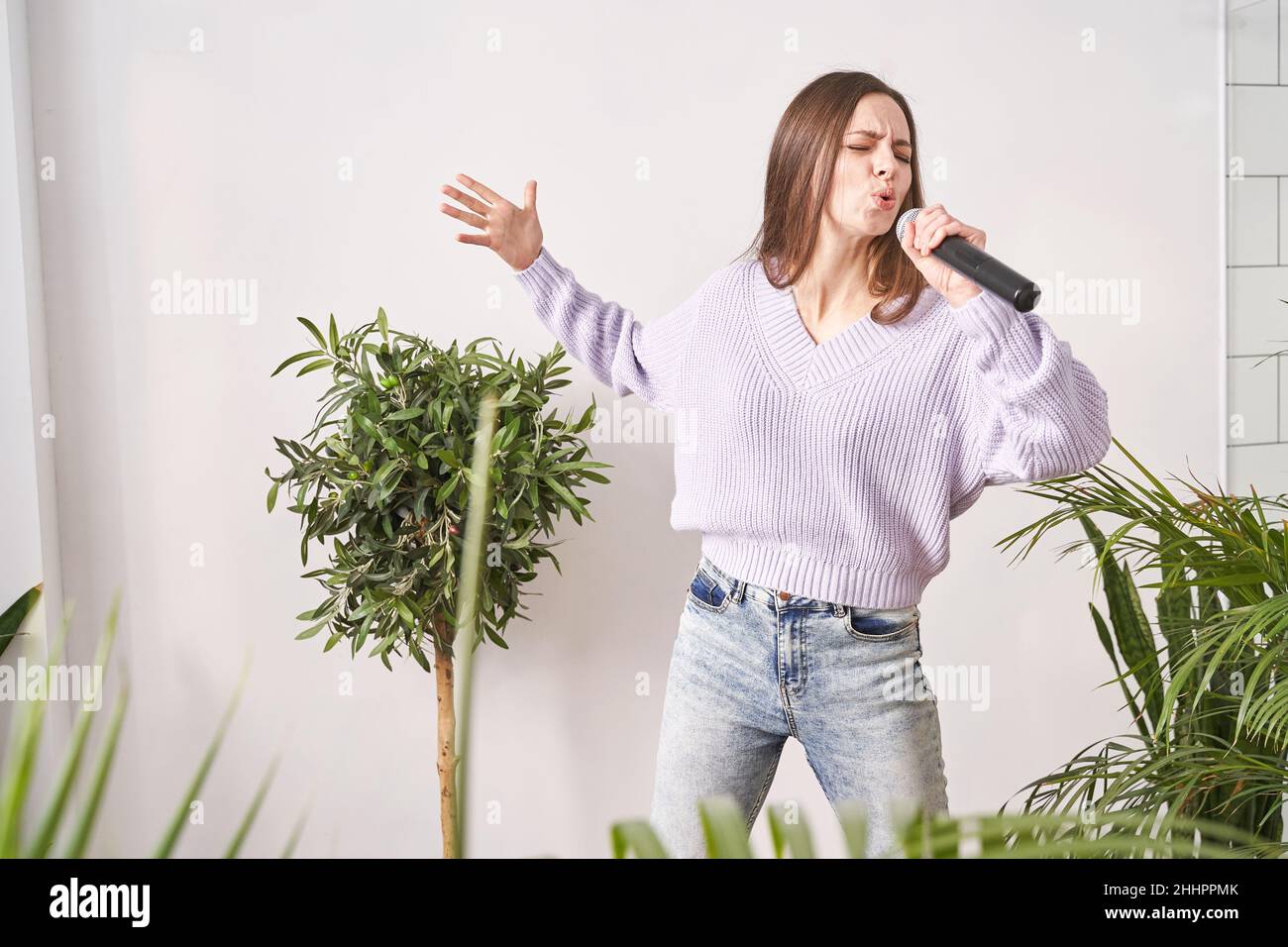 Young woman sing at home. Karaoke black microphone. House lyrics dance ...