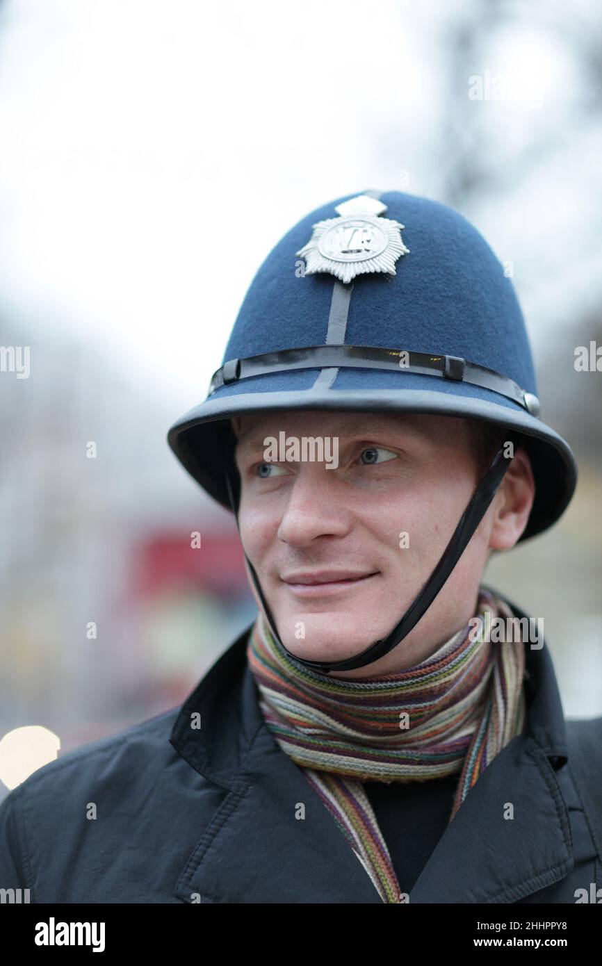 The happy man posing in british police hat Stock Photo - Alamy