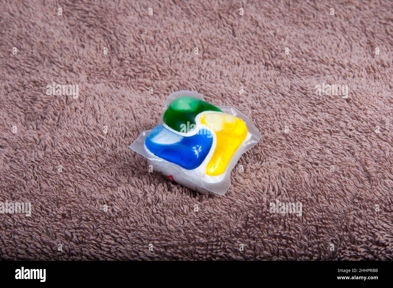 Washing color gel capsule on the brown cloth texture Stock Photo - Alamy