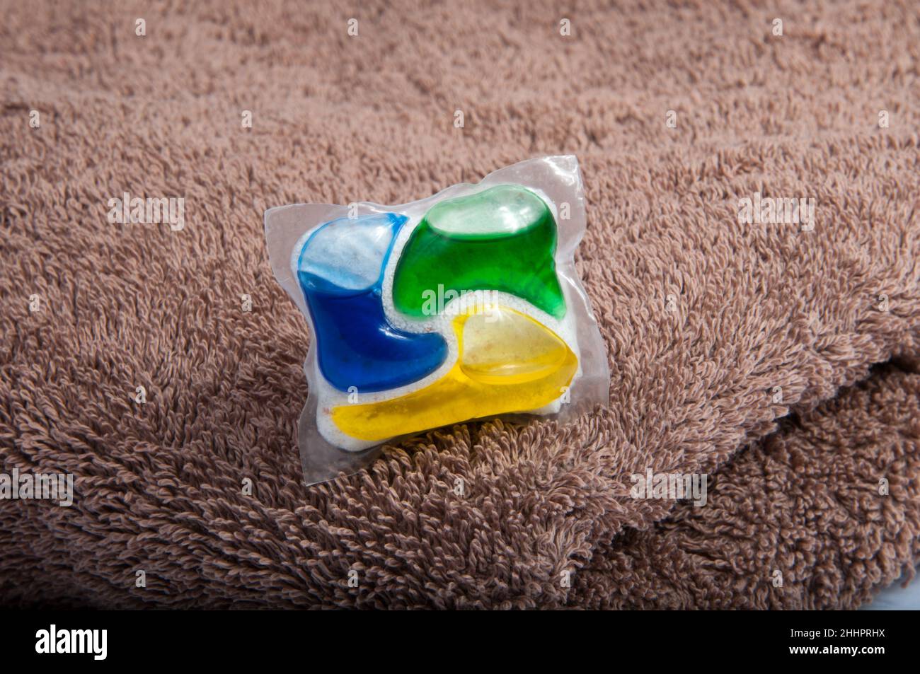 Washing color gel capsule on the brown cloth texture Stock Photo - Alamy