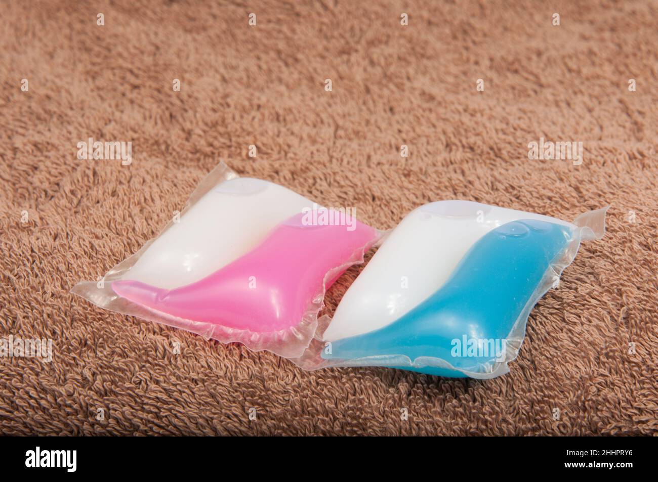Washing color gel capsule on the brown cloth texture Stock Photo - Alamy