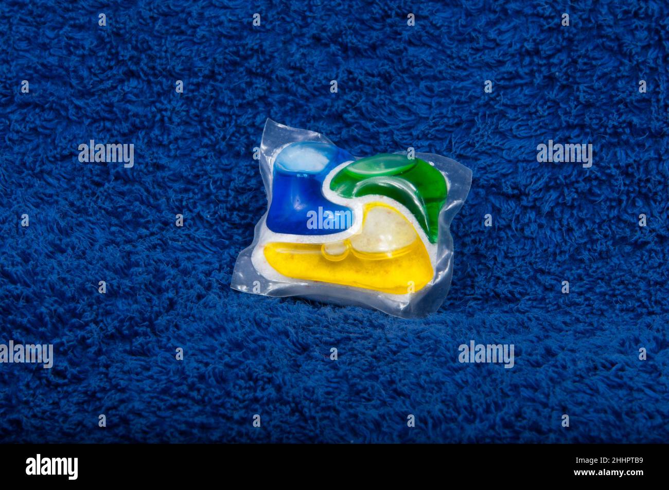 Washing color gel capsule on the blue cloth texture Stock Photo - Alamy