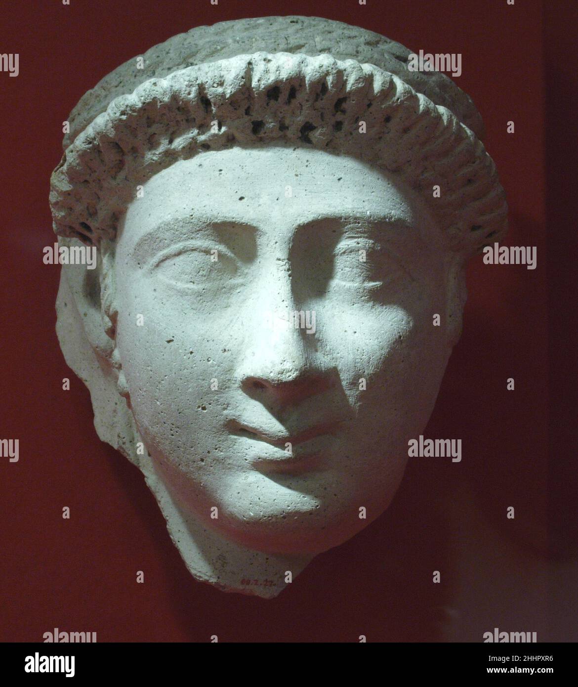 Mask of a woman with an ornate curled bang and loop earrings A.D. 98 ...