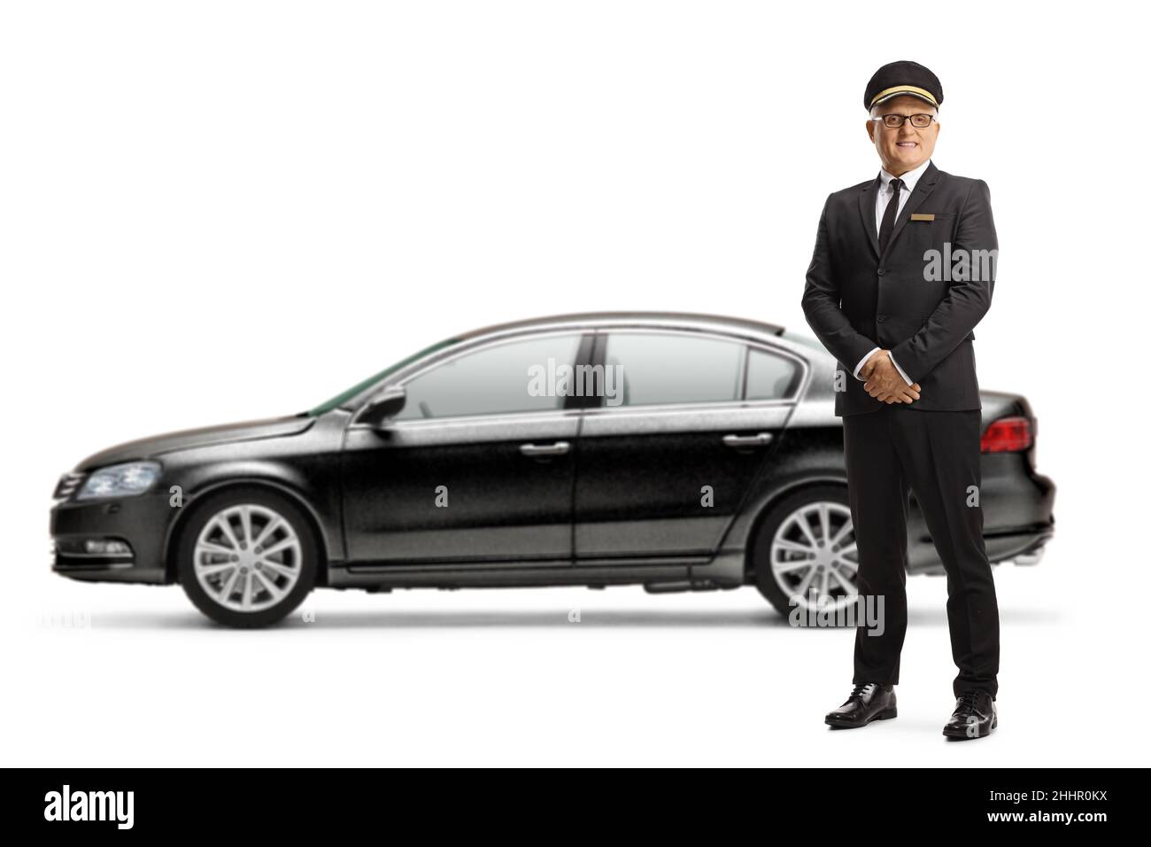 Full length portrait of a chauffeur in a uniform standing in front of a ...