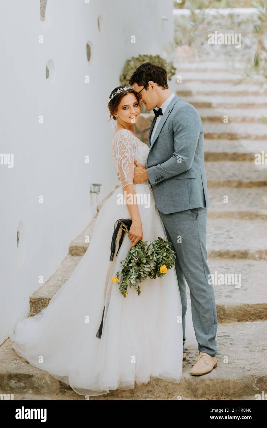 beautiful bride and groom in their summer wedding day on greek island ...