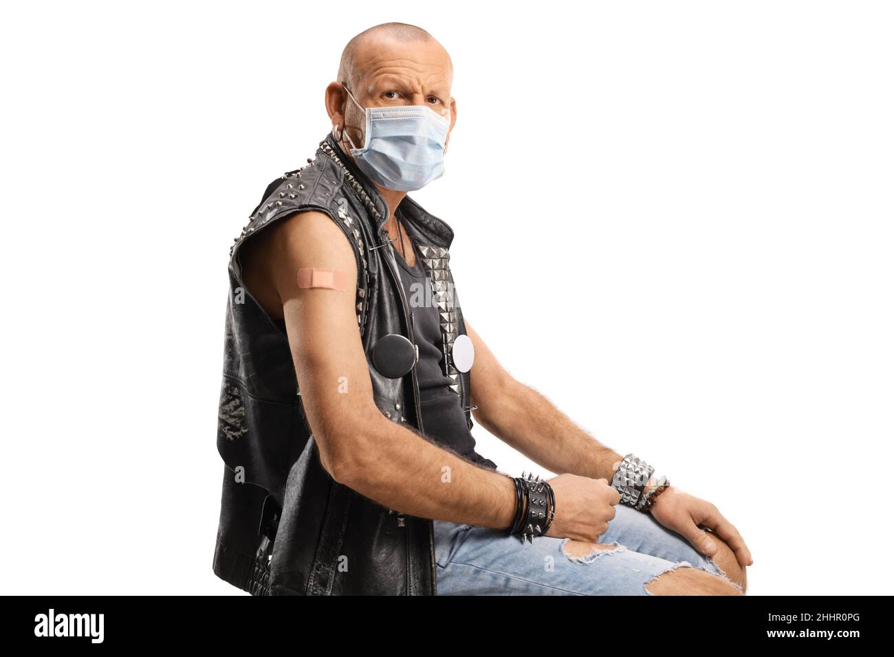 Bald man with a leather vest sitting a vaccine patch on his arm ...
