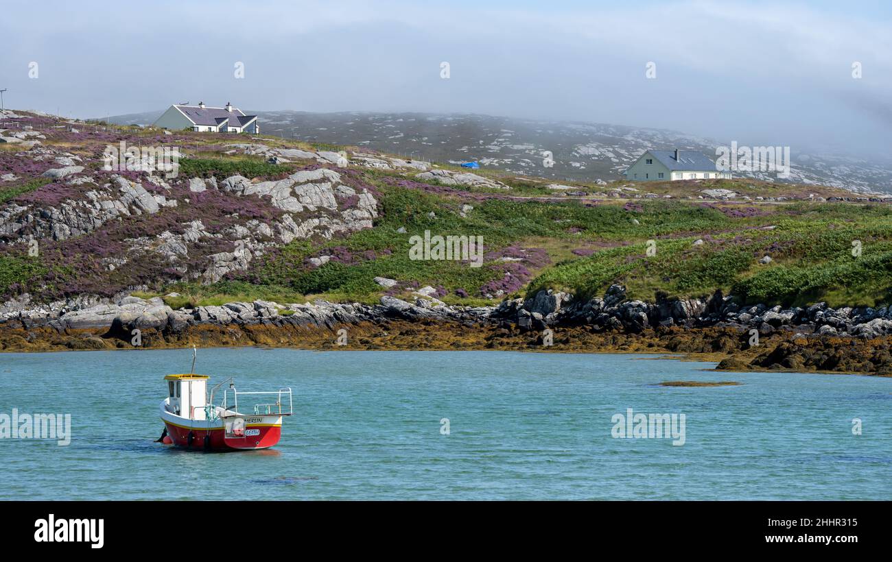 View towards a red boat and residential houses of the village of Ludag ...