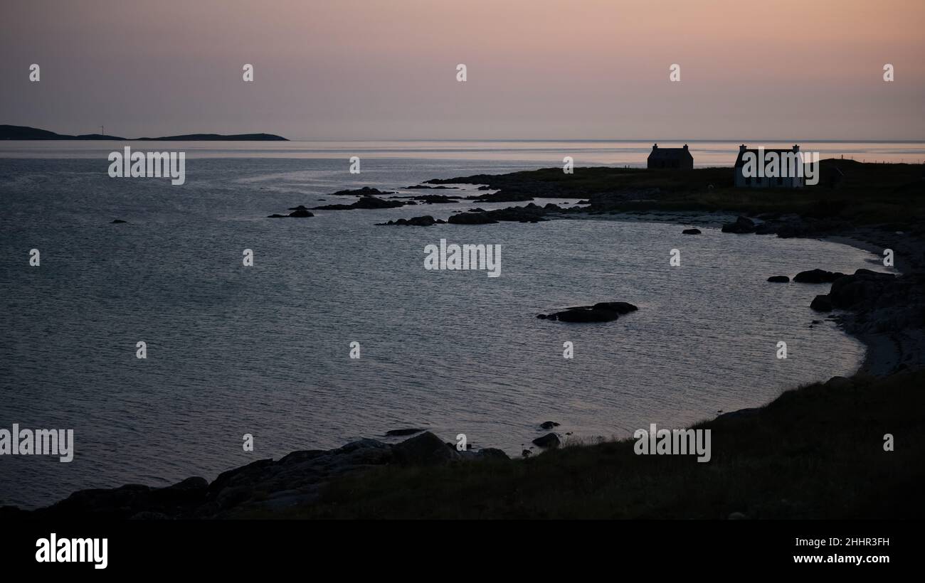 View towards cottages in the village of Ludag near Eriskay Causeway ...