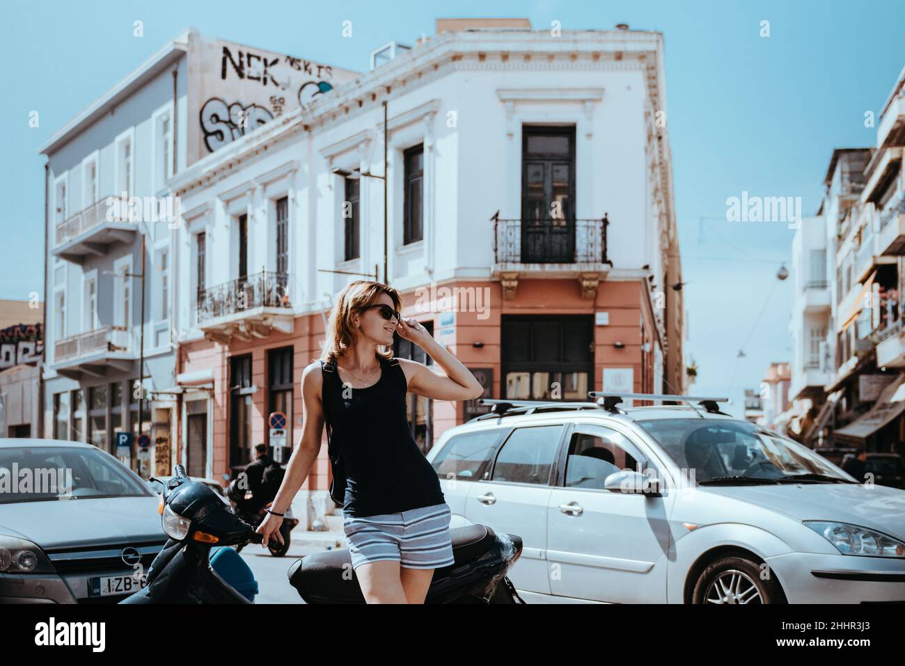 Beautiful girl walking along the street of an old European town ...