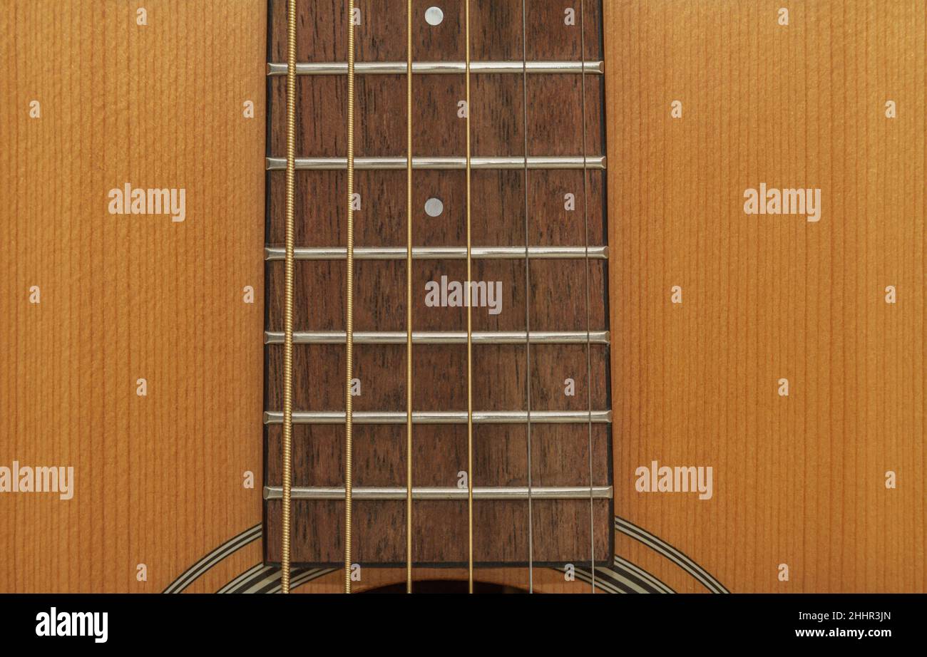 Closeup view of a six string acoustic guitar with wood grain Stock ...