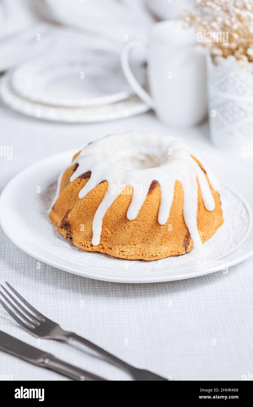 Easter cake with colorful eggs in a chocolate nest on white background ...