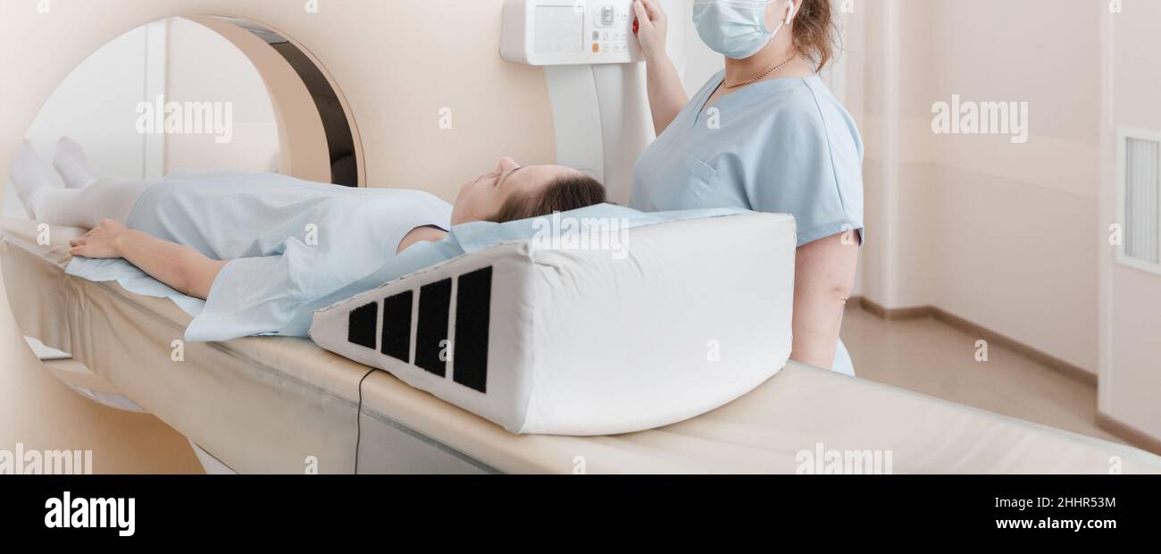 Doctor or nurse and patient with tomography CT or MRI Scan in hospital ...