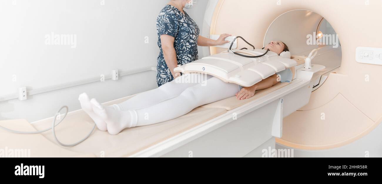 Doctor or nurse and patient with tomography CT or MRI Scan in hospital ...