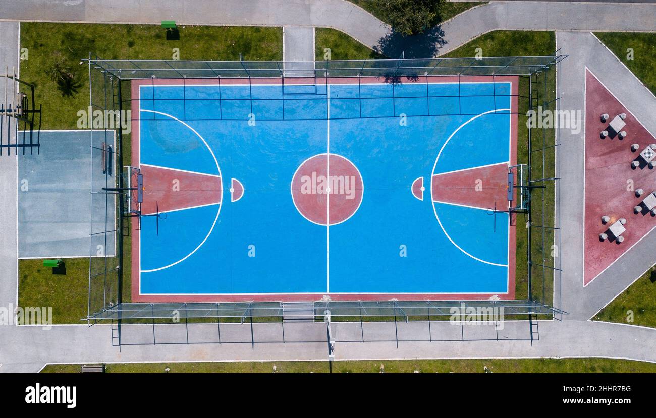 Multisport court seen at 90 degrees from a drone in blue and red colors ...