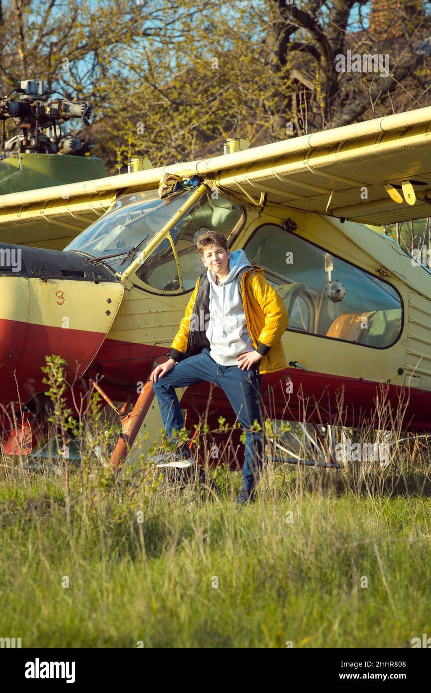 A young man in front of an old abandoned Soviet plane. The guy enjoys ...