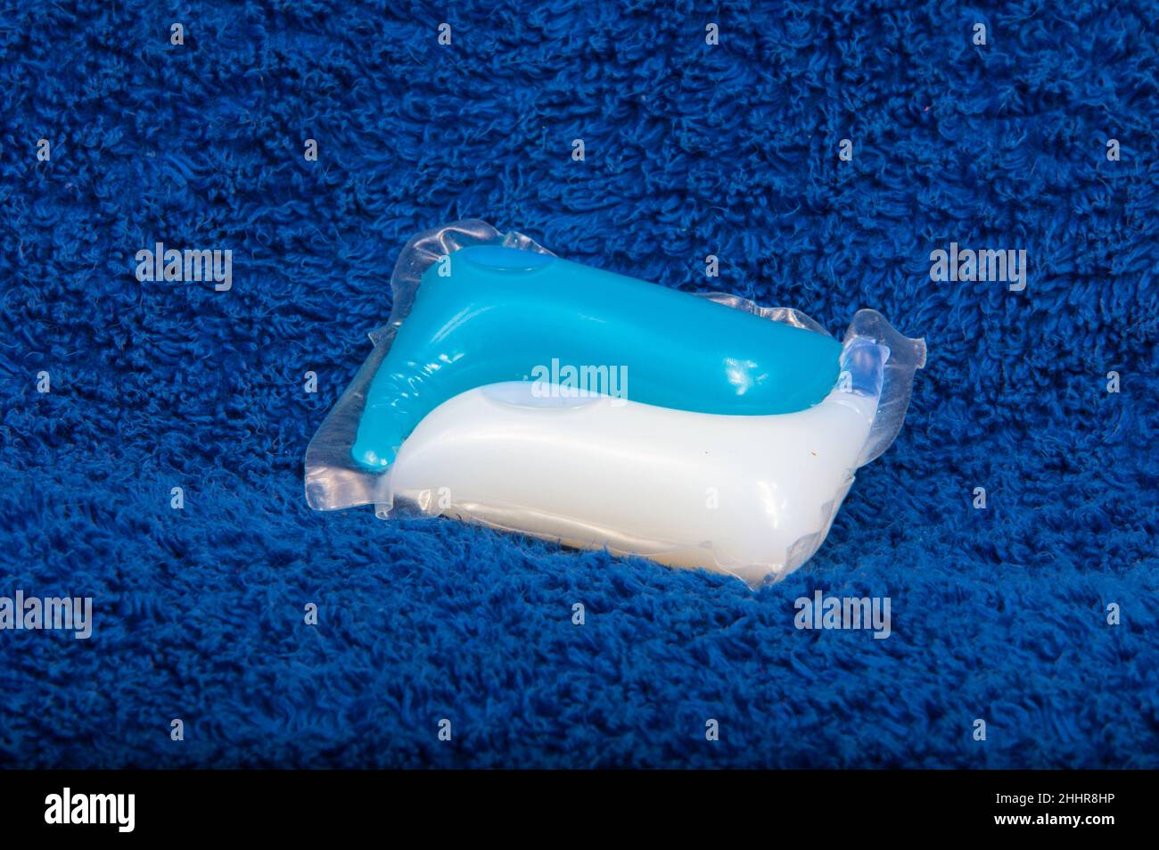 Washing color gel capsule on the blue cloth texture Stock Photo - Alamy