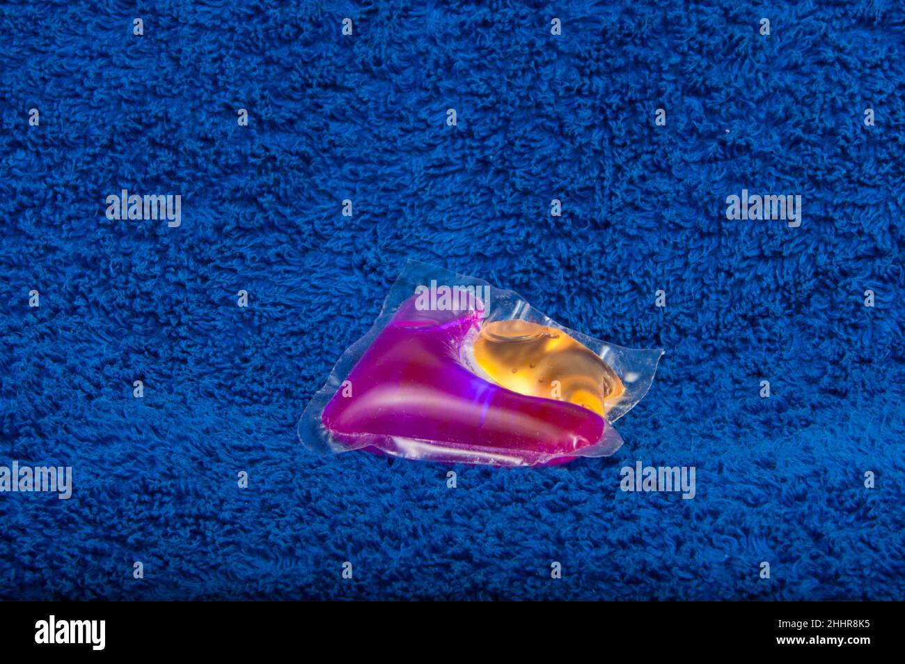 Washing color gel capsule on the blue cloth texture Stock Photo - Alamy