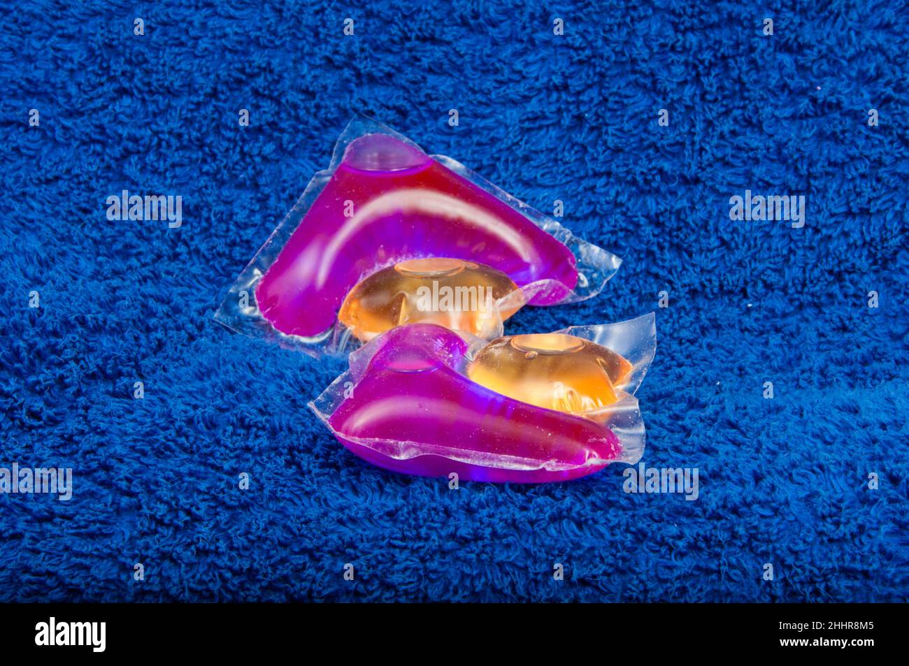 Washing color gel capsule on the blue cloth texture Stock Photo - Alamy