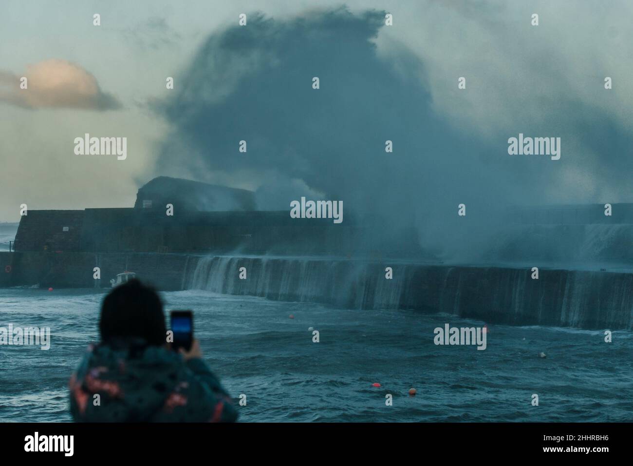 Waves crash over Dunbar harbour walls as the East coast of Scotland is ...