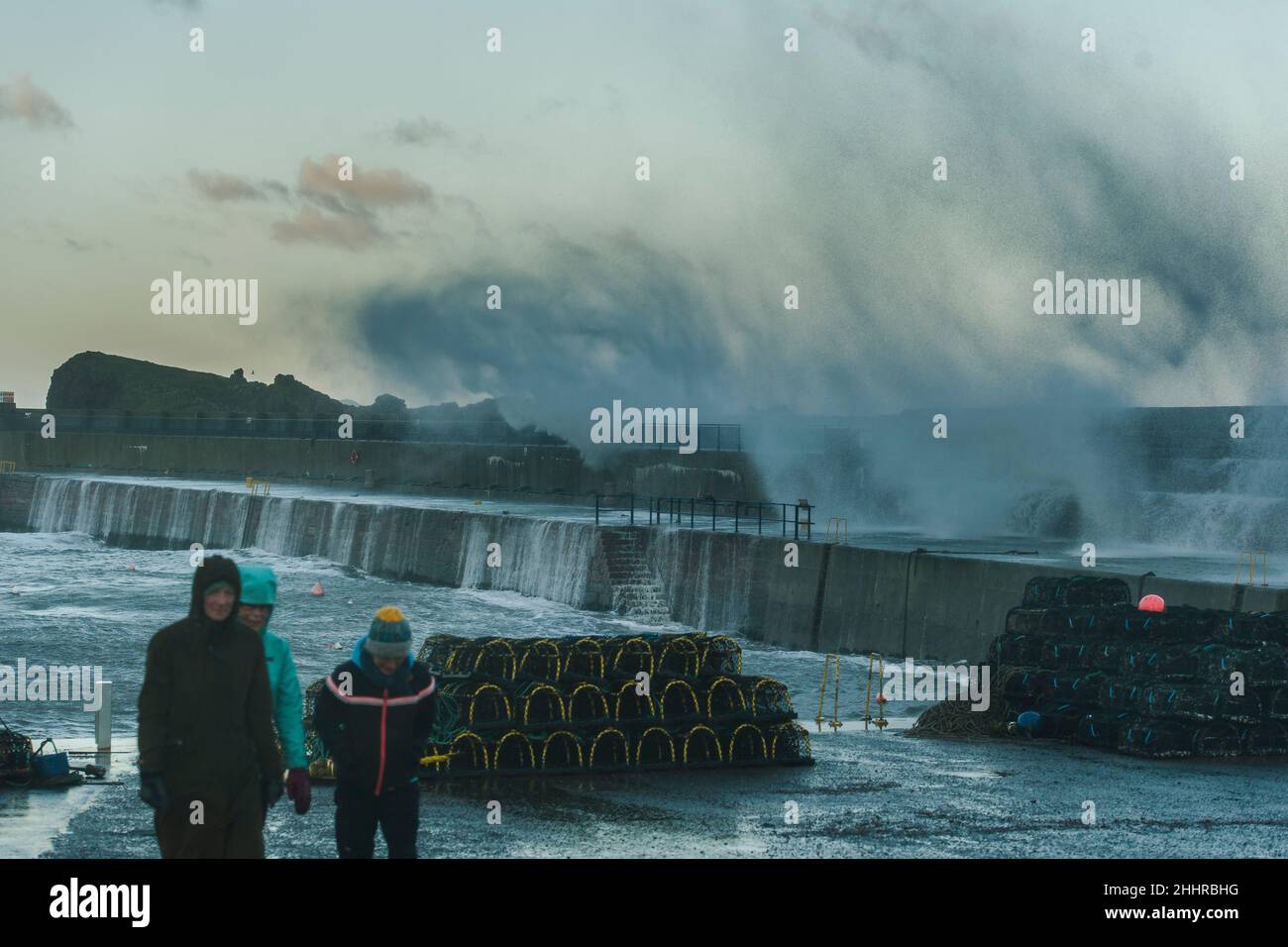 Waves crash over Dunbar harbour walls as the East coast of Scotland is ...