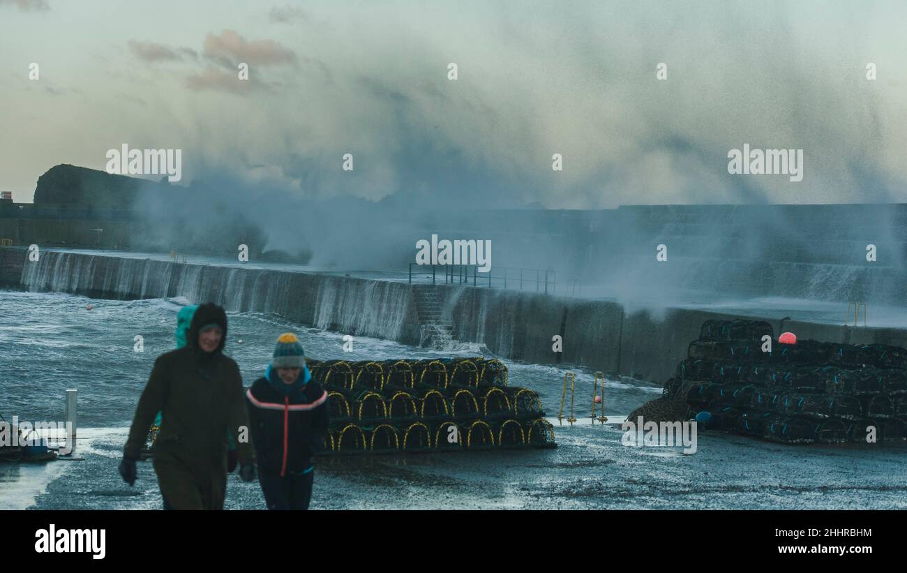 Waves crash over Dunbar harbour walls as the East coast of Scotland is ...