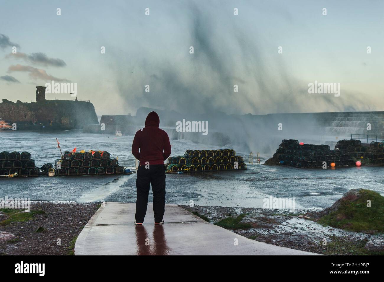 Waves crash over Dunbar harbour walls as the East coast of Scotland is ...