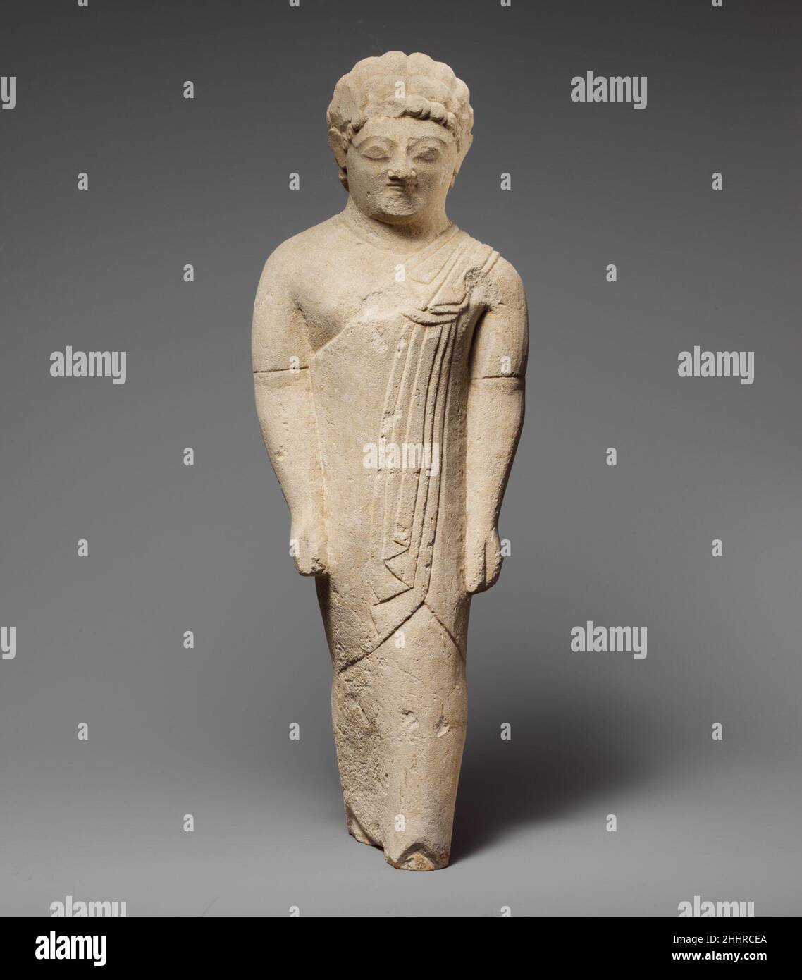 Limestone statuette of a beardless male votary in Greek dress late 6th ...
