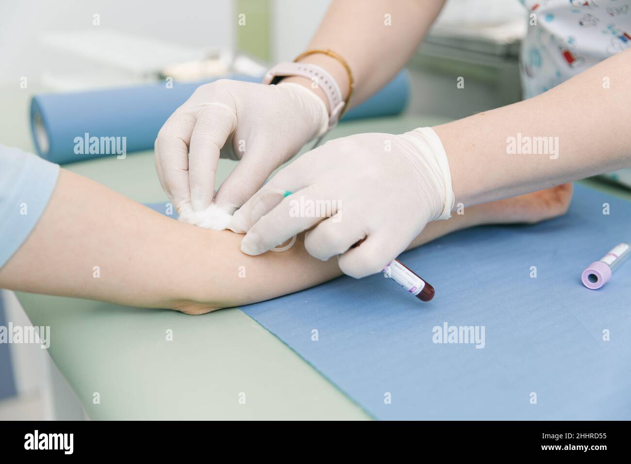 Taking a blood test from a vein in the treatment room. Nurse pricking a ...