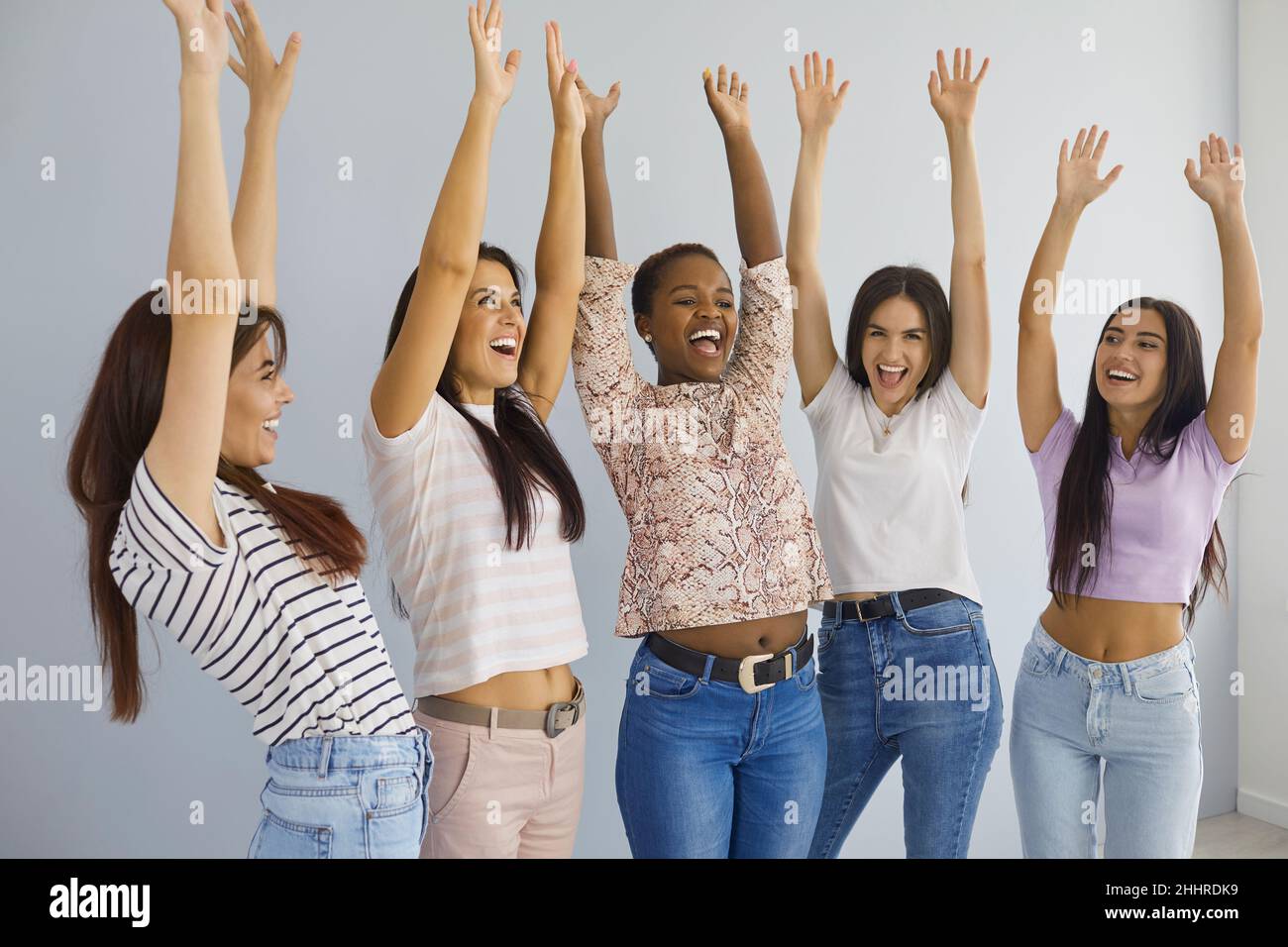 Overjoyed gen z girls celebrate shared victory Stock Photo - Alamy