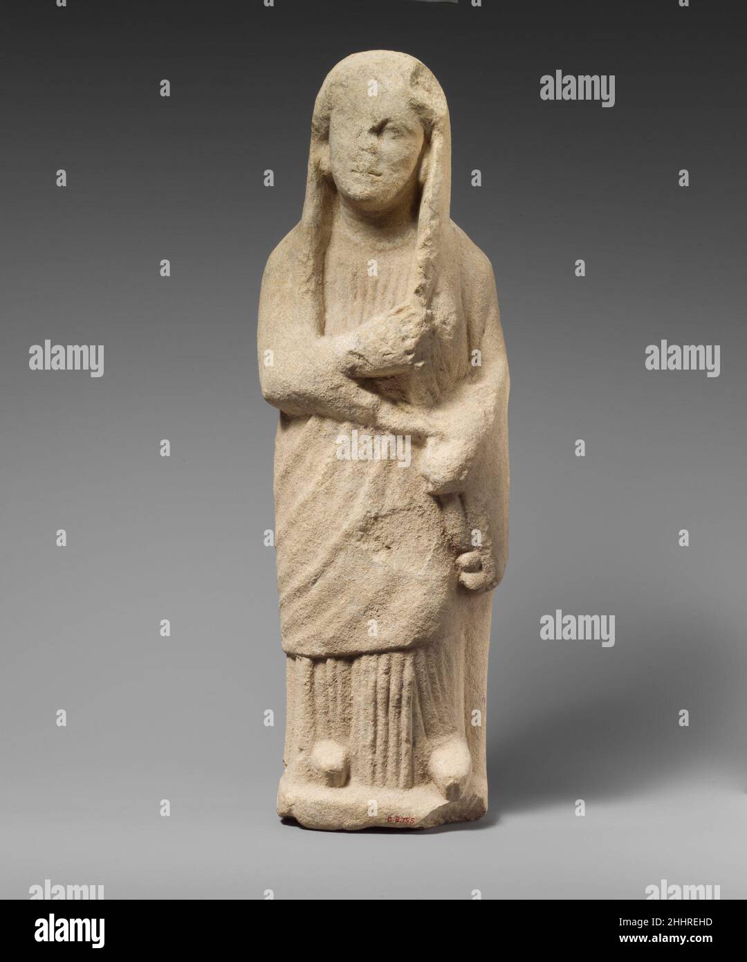 Limestone statuette of a female votary Cypriot Figure with cloak drawn ...