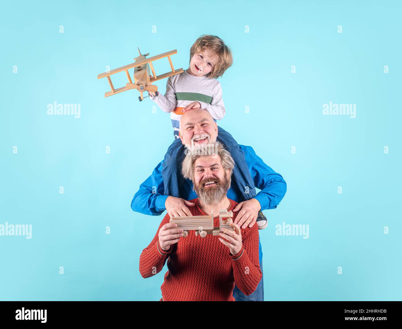 Grandfather father and grandson playing with toy plane. Boy dreams of ...