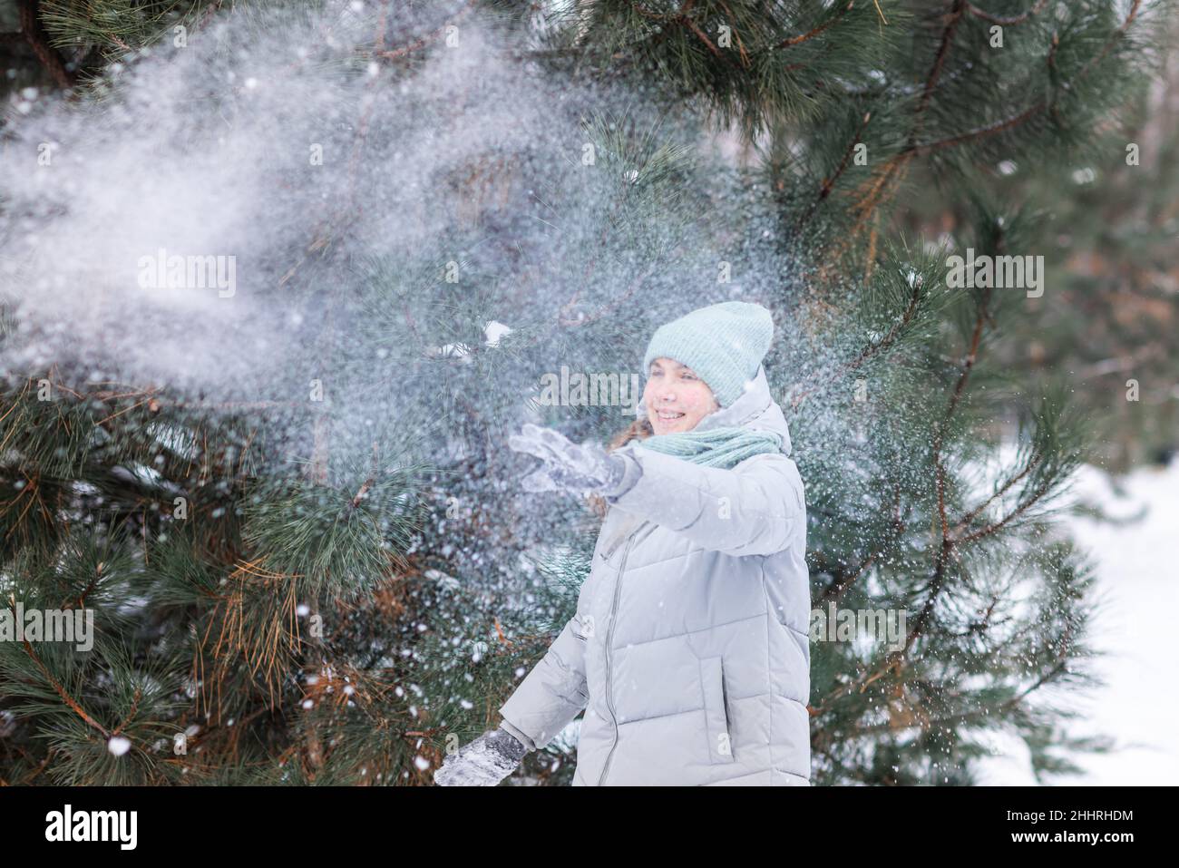 Happy teenage girl having fun playing with snowballs, ready to throw ...