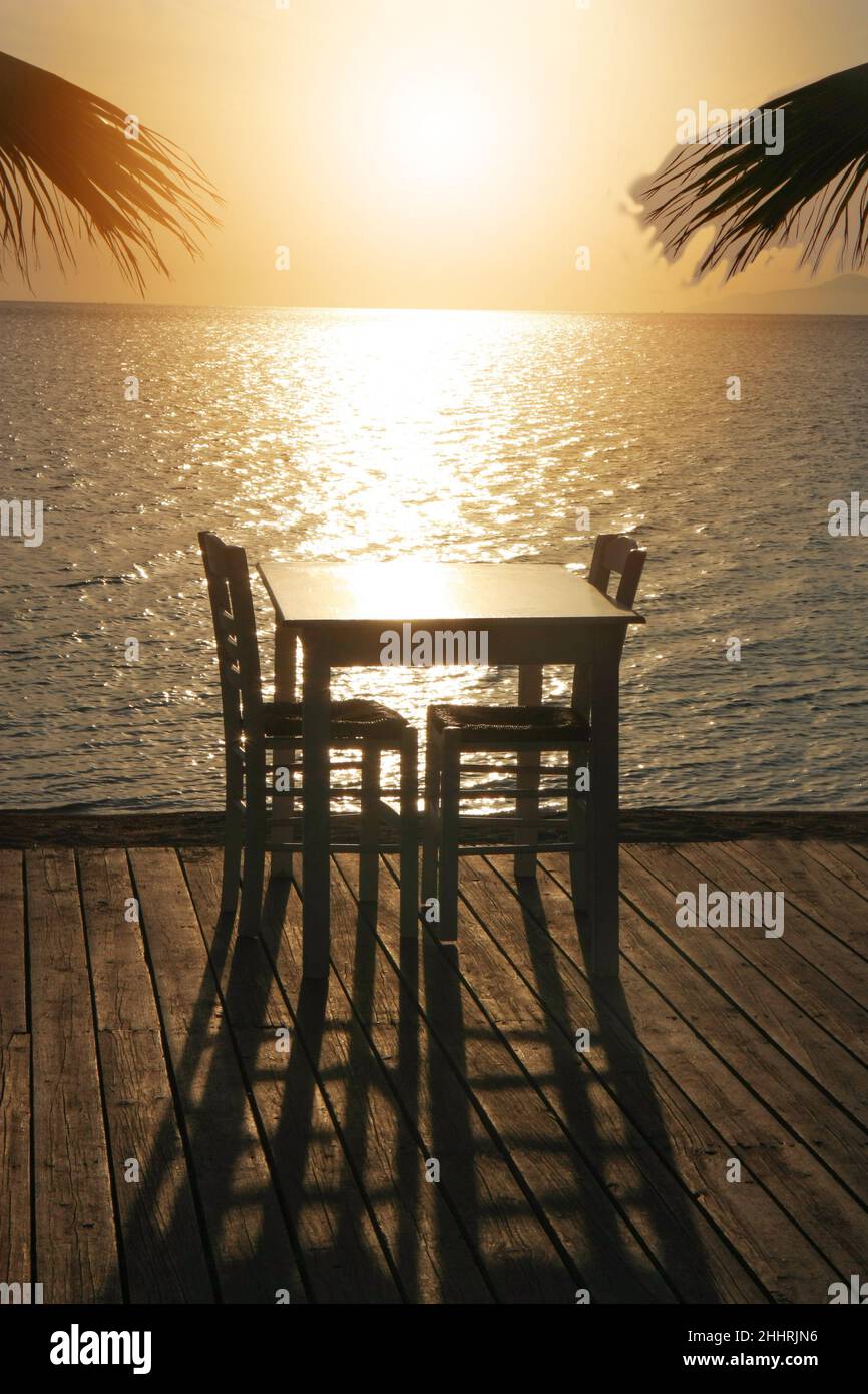 The romantic scene on the beach with a table for two at the restaurant ...