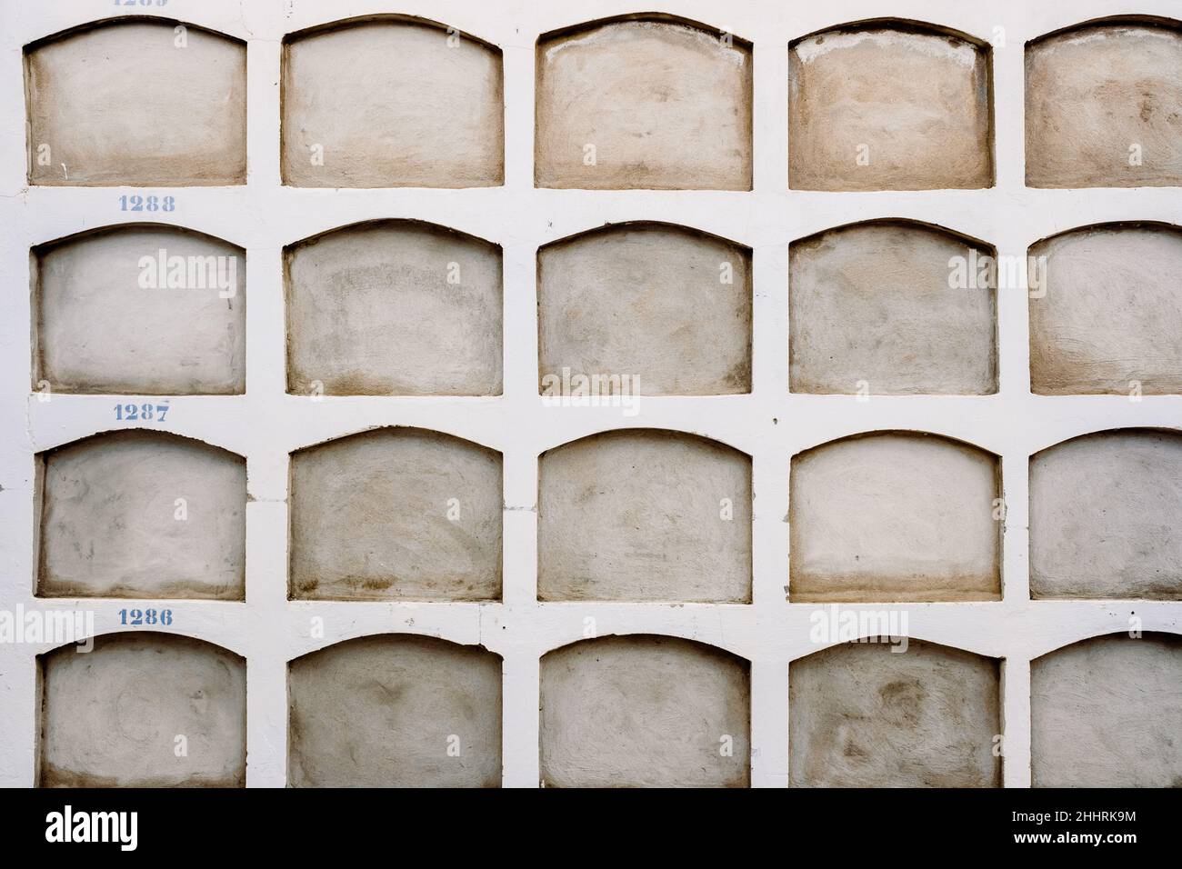 Wall of a cemetery with the holes of the niches one on top of the other ...
