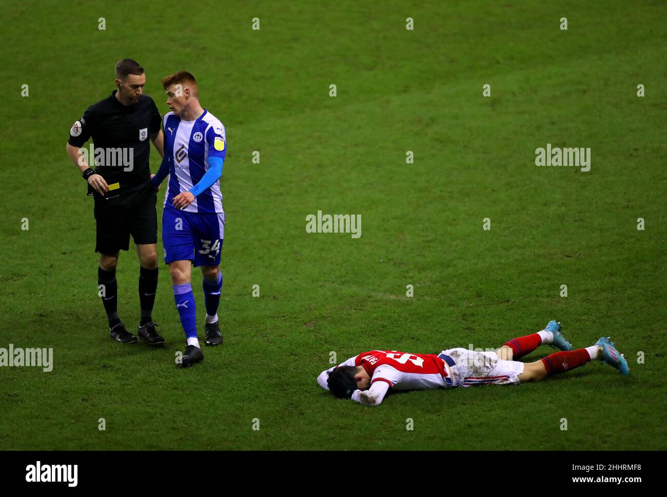 Arsenal's Charlie Patino (right) lies on the pitch after a challenge ...
