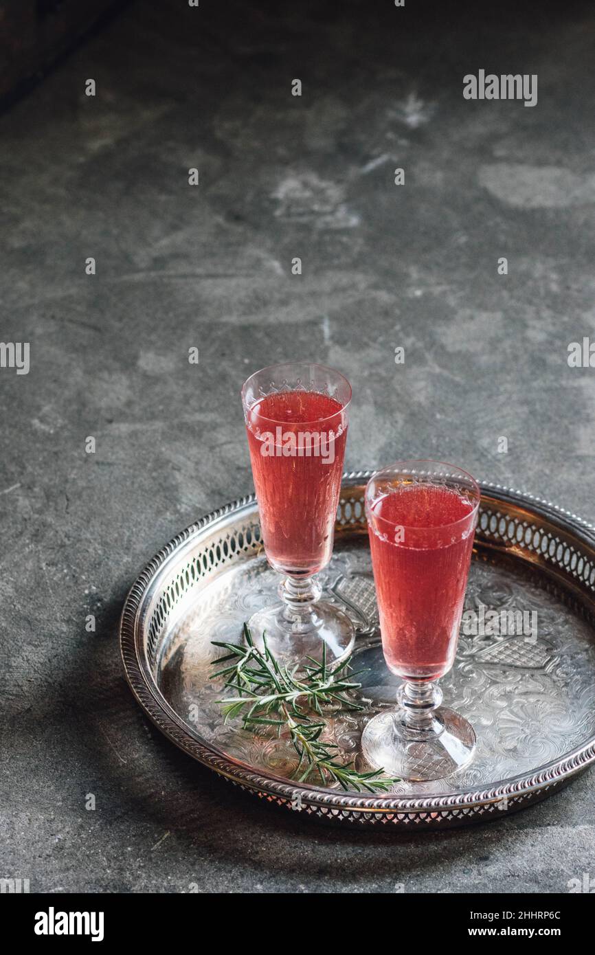 two pink sparkling cocktails in champagne flutes on silver tray Stock ...