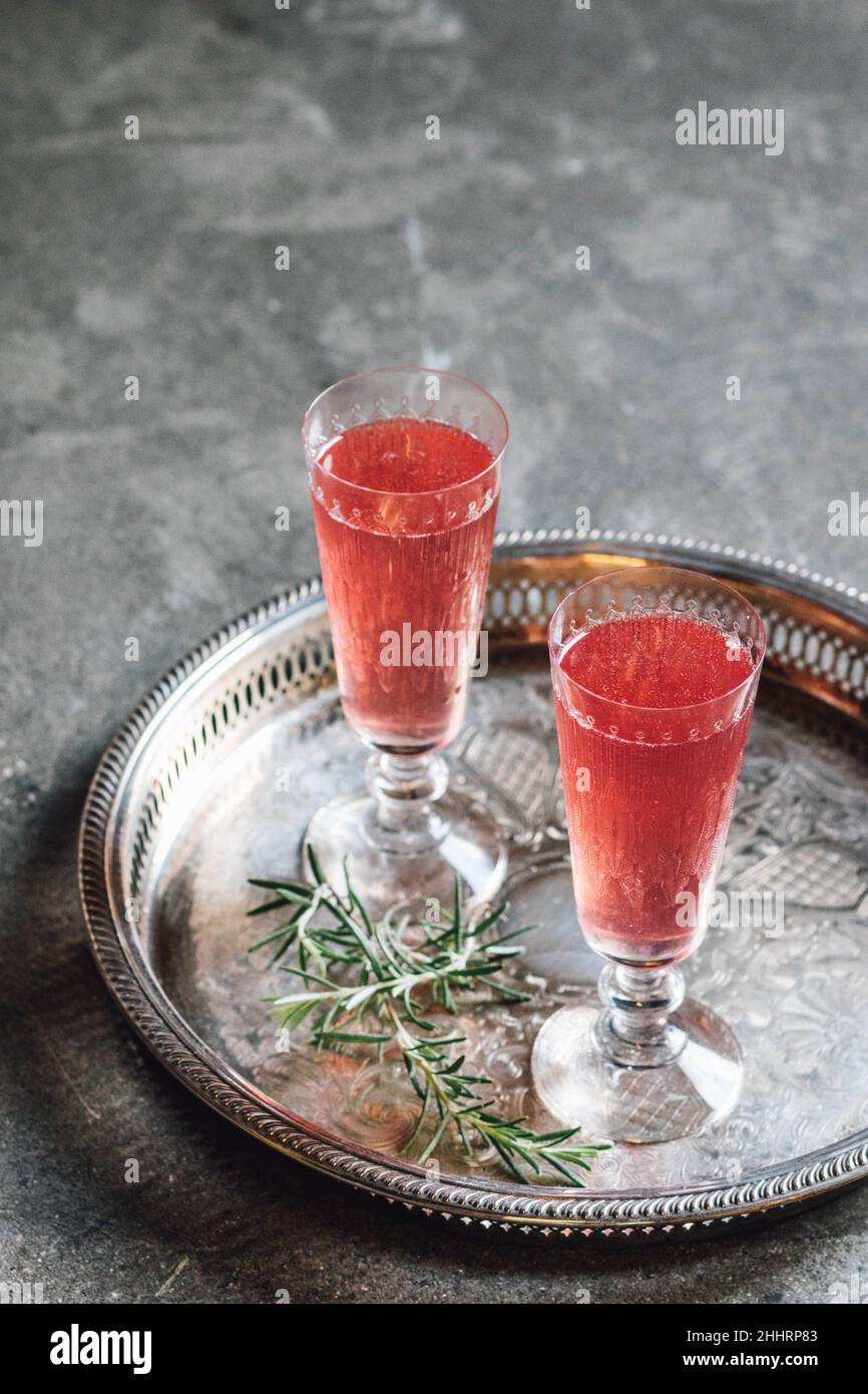 two pink sparkling cocktails in champagne flutes on silver tray Stock ...