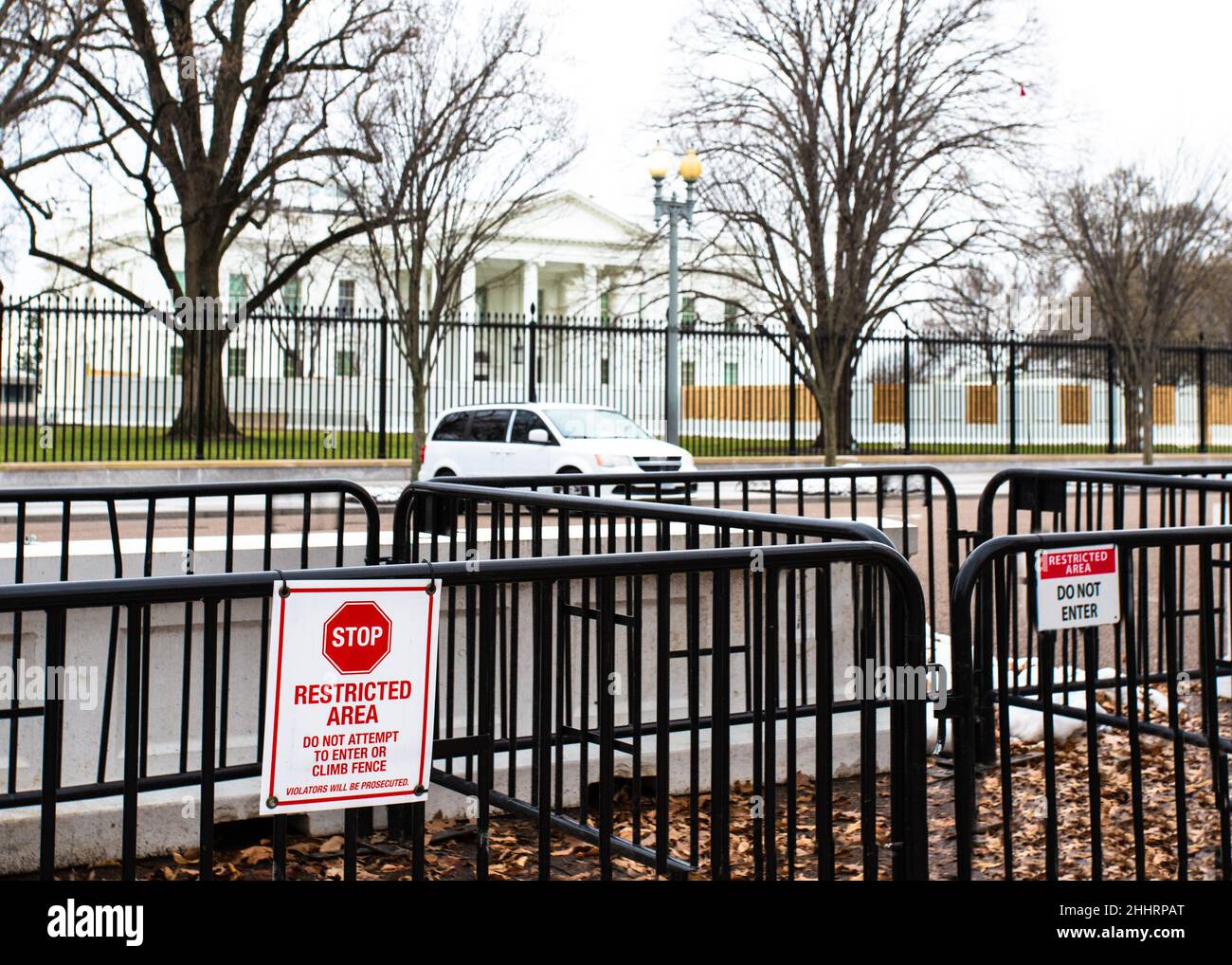 Restricted area warning sign on barricade fence surrounding the White ...
