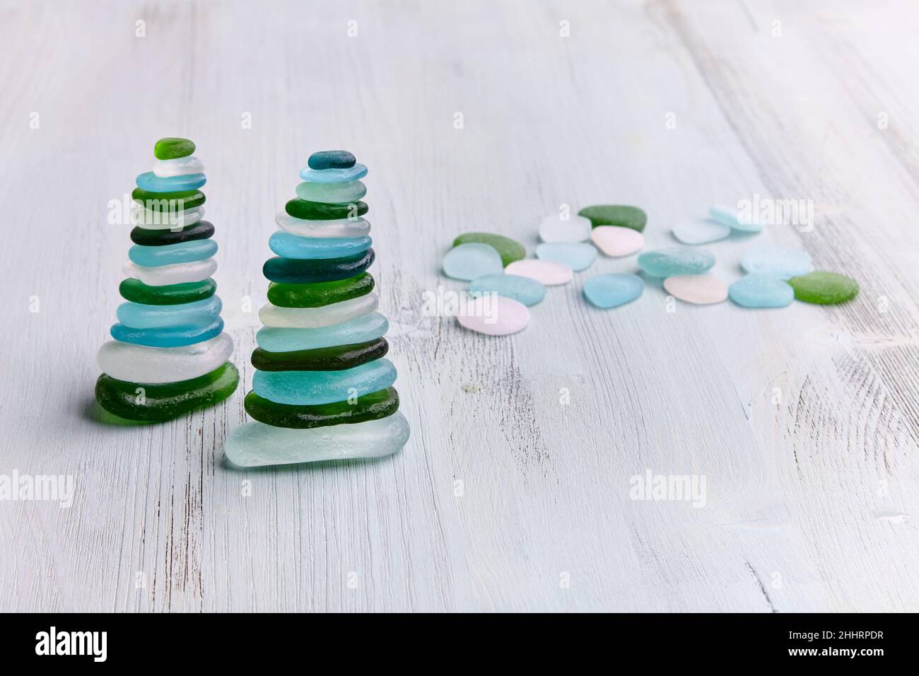 Two zen pyramids on a beach wooden sun bed Stock Photo - Alamy