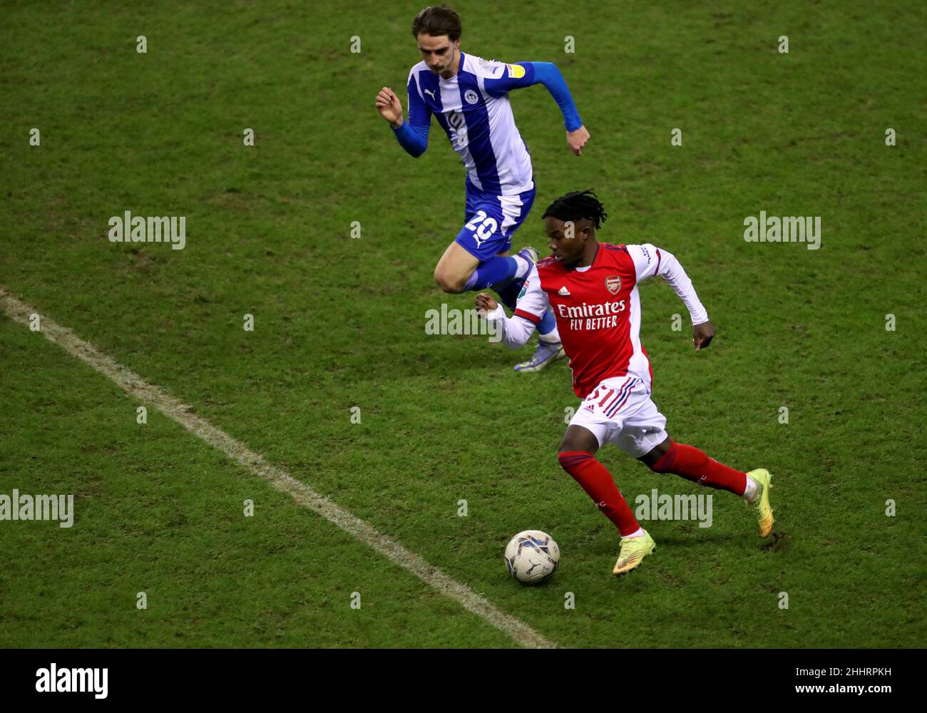 Arsenal's Joel Ideho (bottom right) and Wigan Athletic's Tom Bayliss ...