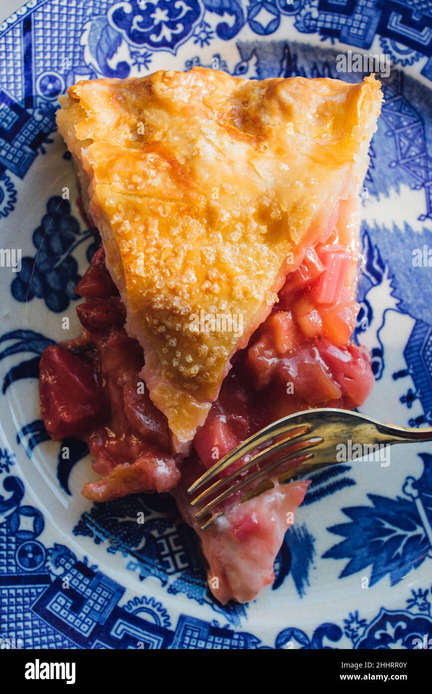 strawberry rhubarb pie slice on blue japanese plate Stock Photo - Alamy