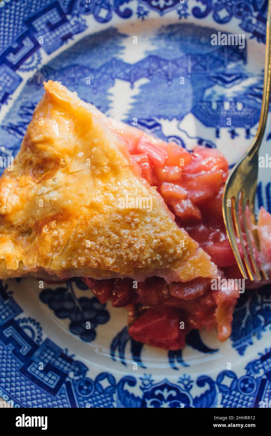 strawberry rhubarb pie slice on blue japanese plate Stock Photo - Alamy