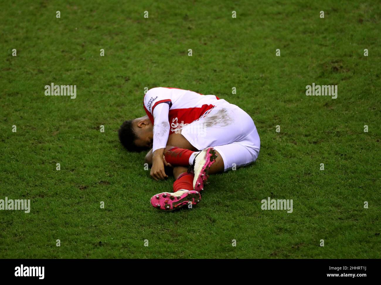 Arsenal's Zach Awe lies injured on the pitch during the Papa John's ...