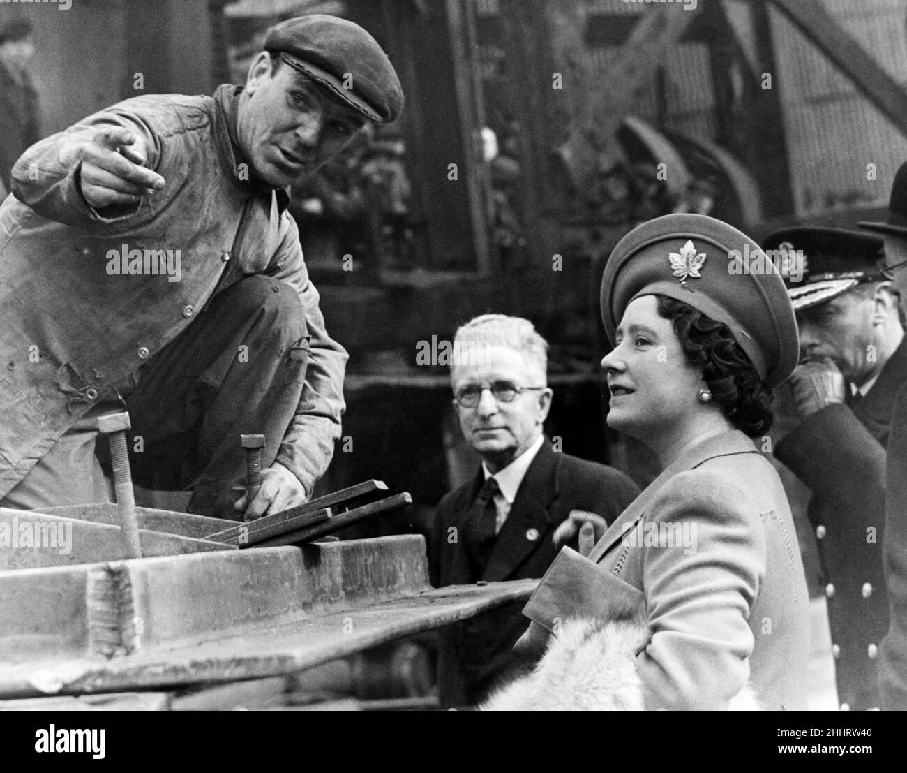 Queen Elizabeth The Queen Mother talking to a shipyard worker, during ...