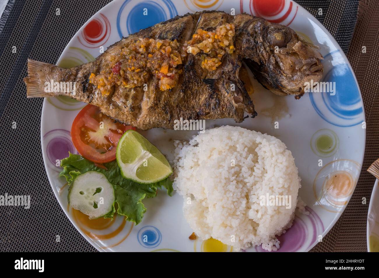 Fried fish with salad and white rice Stock Photo - Alamy