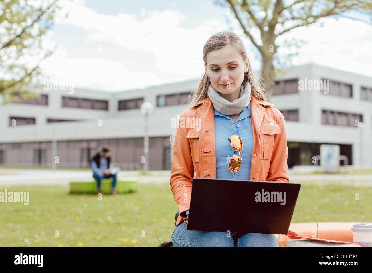 Student sitting on campus of university with her laptop Stock Photo - Alamy
