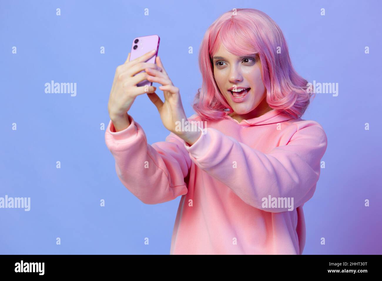 woman holding a phone posing technology isolated background Stock Photo ...