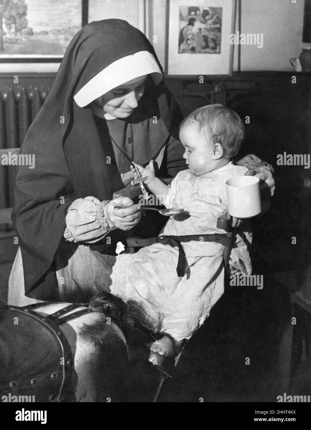 Nun holding a baby hi-res stock photography and images - Alamy